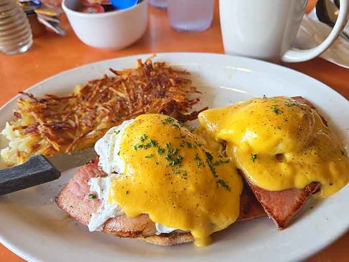 Eggs benedict with hollandaise cascading like a delicious waterfall&mdash;this is morning perfection on an English muffin throne.