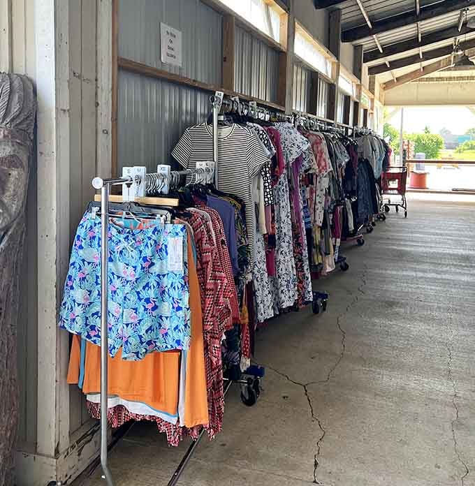 Clothing racks under open-air shelter prove bargain hunting doesn't require fancy dressing rooms or pretentious lighting.
