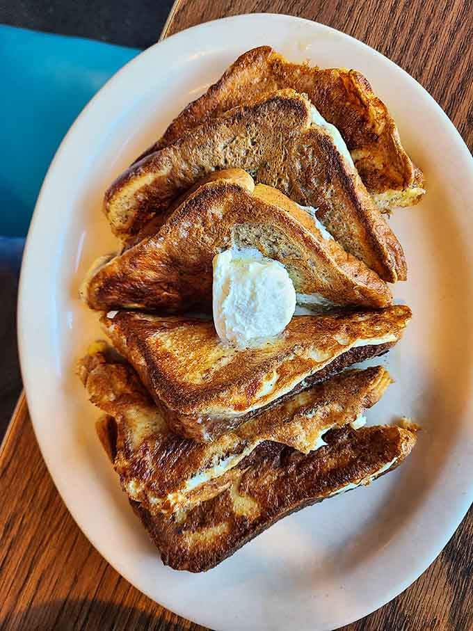 French toast stacked high and golden brown, proving that sometimes simple breakfast done right beats fancy any day.