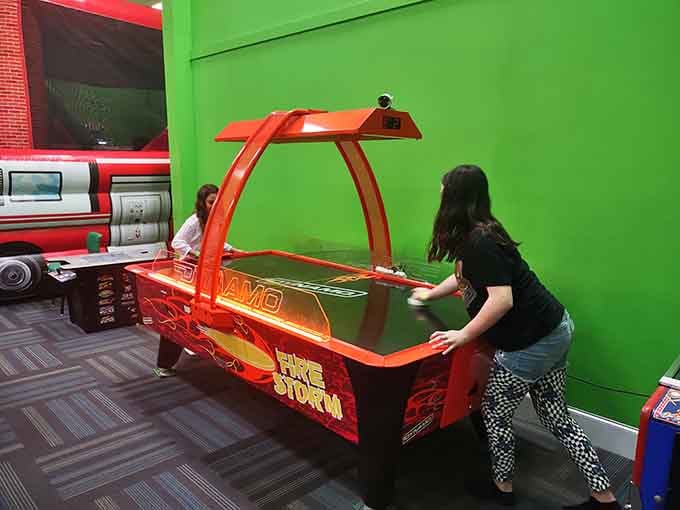 Air hockey's fiery red glow against lime green walls proves the '80s never really left us.