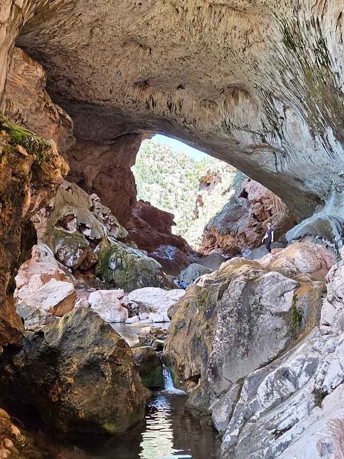 Standing beneath this natural arch feels like discovering a hidden room in a house you thought you knew.