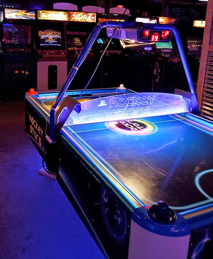 Air hockey tables gleaming under the lights, where friendships are tested and bragging rights are earned with every puck.