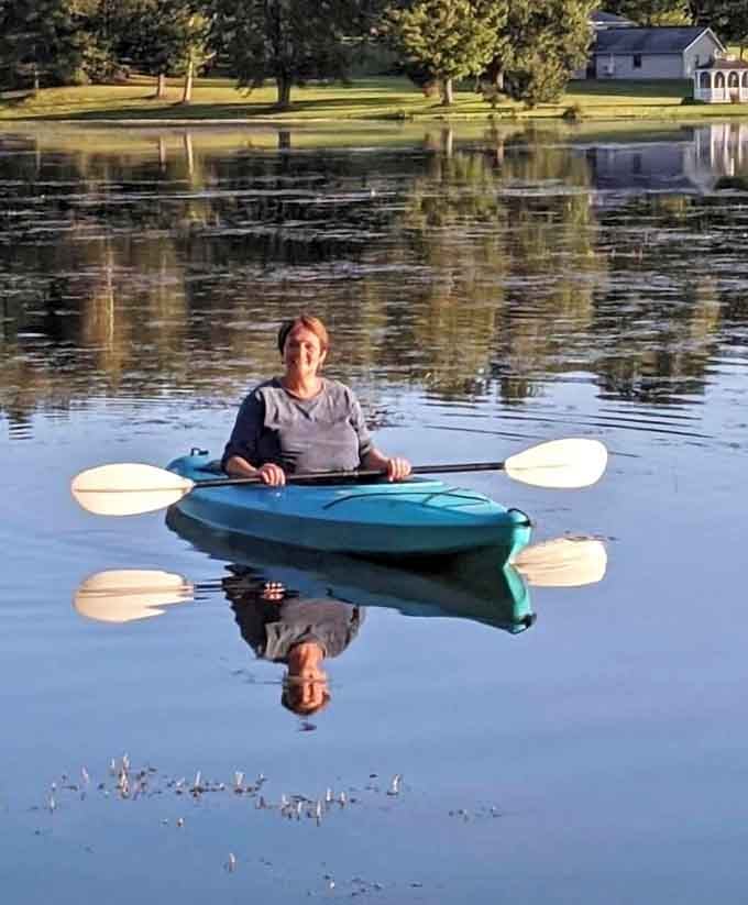 Mirror-perfect water like this makes every kayaker feel like they're paddling through a postcard they're creating in real-time.