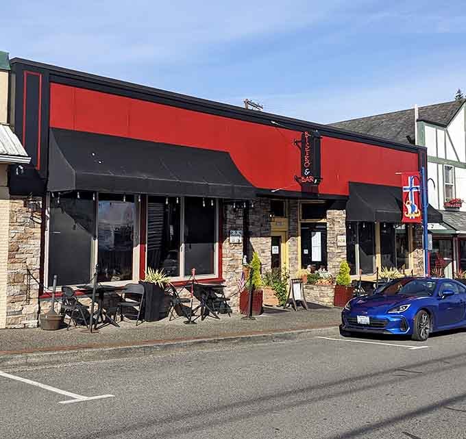Bold red awnings and outdoor seating signal a dining spot where European flair meets Pacific Northwest hospitality perfectly.