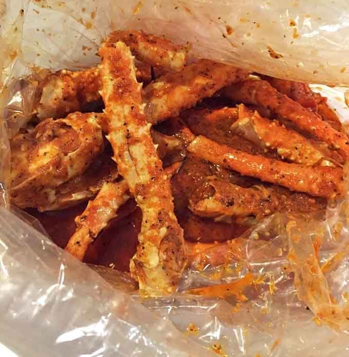 King crab legs glistening with seasoned butter prove that sometimes the messiest meals are the most memorable ones.