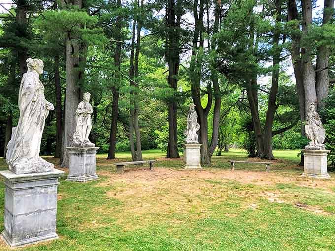 Classical statues standing watch over grounds that could double as a European estate's backyard.
