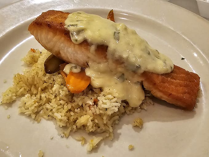 Salmon draped in creamy sauce over rice proves they handle seafood with the same mastery.