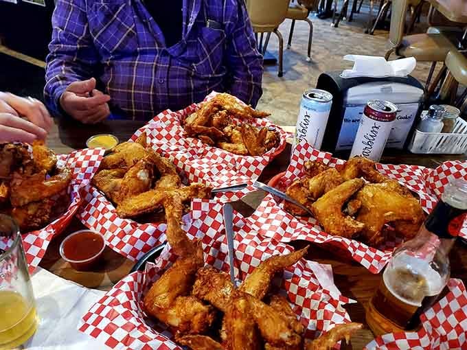 A table full of perfectly fried wings in red checkered baskets, this is what happiness looks like.