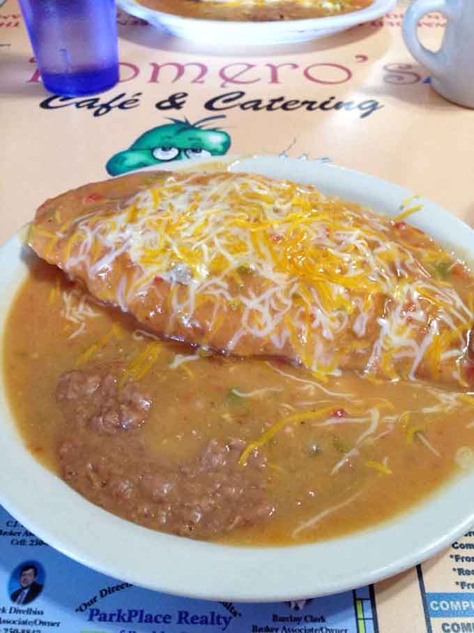 The stuffed sopapilla swims in green chile like it's taking the world's most delicious bath imaginable.