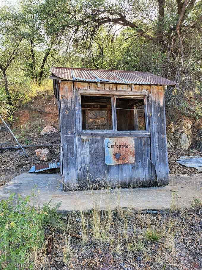 This tiny guard shack still stands watch, its rusted sign a reminder that someone once monitored every coming and going.
