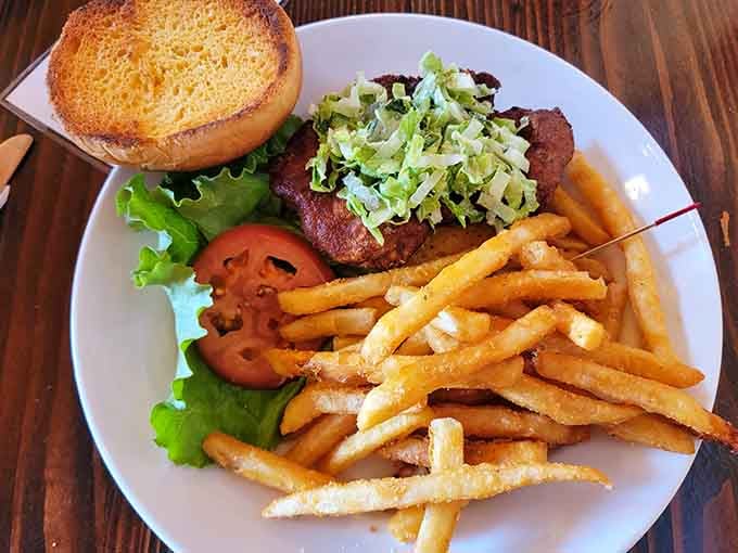 A burger topped with crispy shreds and golden fries proves that simple done right beats fancy done wrong.