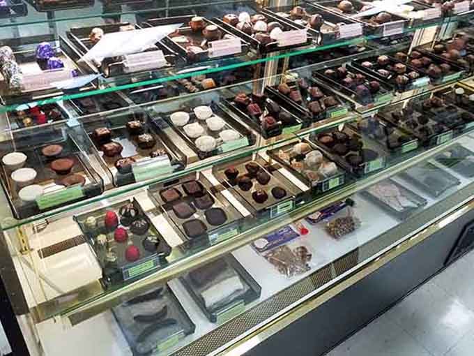 Glass cases filled with handcrafted chocolates that look too beautiful to eat, but you absolutely will anyway.