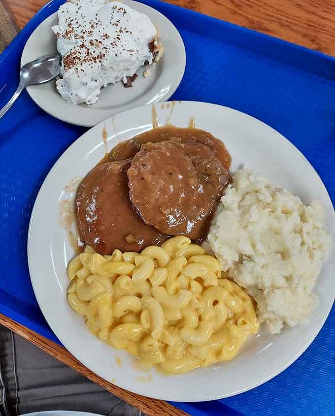 Salisbury steak swimming in rich gravy alongside creamy mac and cheese is comfort food at its finest.