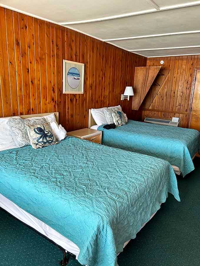 Twin beds dressed in turquoise spreads prove that sometimes matching your decor to the ocean is absolutely the right call.