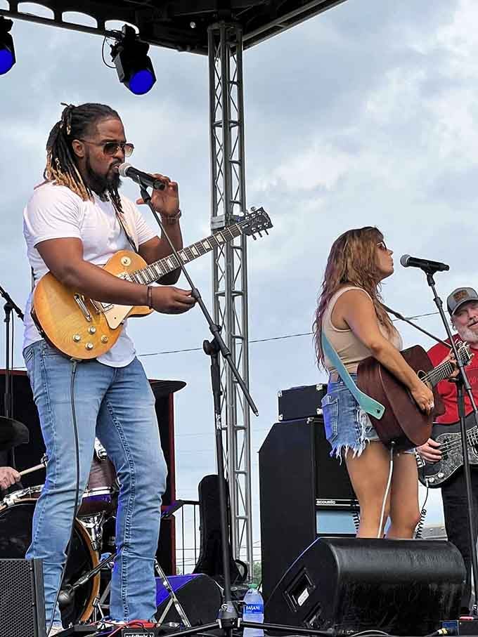 Live music fills the air while guitars strum and the crowd sways under Alabama's summer sky.