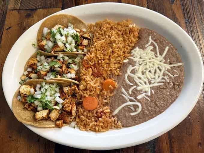 Soft tacos loaded with perfectly seasoned chicken, rice, and beans that'll ruin you for drive-through forever after this.