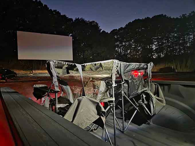 Lawn chairs in a truck bed facing the big screen: someone here understands the assignment perfectly.