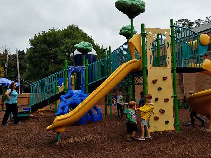 The playground's whimsical dinosaur slide proves that prehistoric creatures and modern fun make excellent companions for energetic kids.