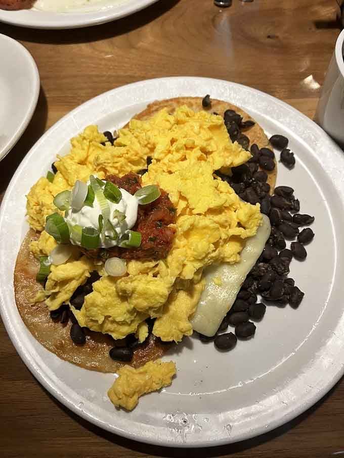 Huevos Rancheros done right, with black beans, scrambled eggs, and enough flavor to wake up your taste buds.