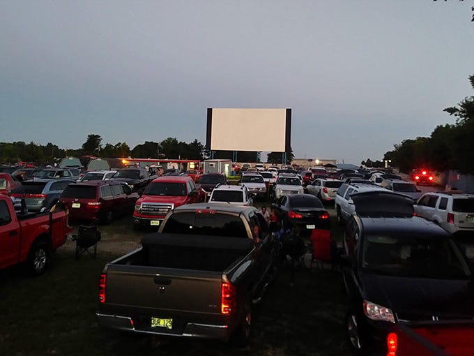Cars lined up like eager theatergoers, each one a private box seat for tonight's double feature.