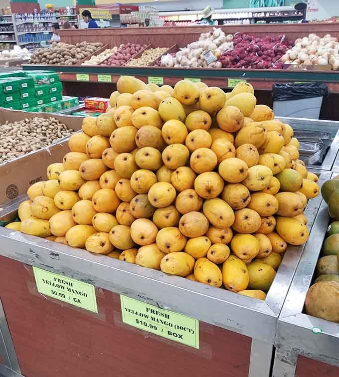 Fresh mangoes piled high like golden treasure, because sometimes fruit shopping should feel like an adventure movie.