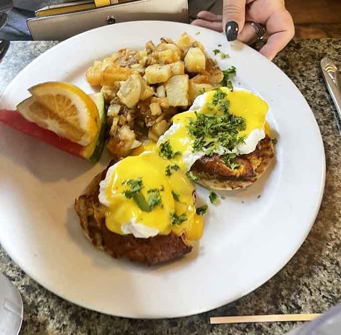 Crab cakes meeting hollandaise at breakfast is the kind of Lowcountry genius that changes your whole brunch philosophy forever.