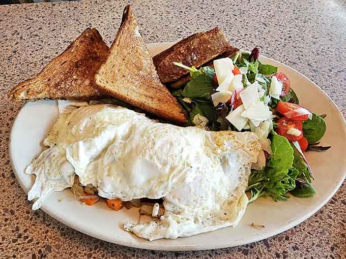 That omelette looks like it's hiding secrets, delicious secrets involving vegetables and melted cheese.