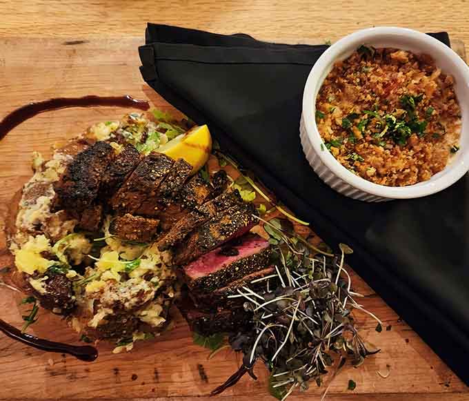 When steak meets lobster thermidor on a wooden board, you know someone's taking dinner seriously.