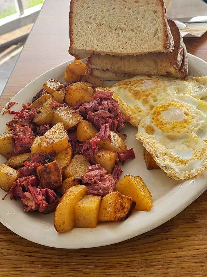 Corned beef hash mixed with potatoes and topped with sunny eggs is comfort food at its finest.