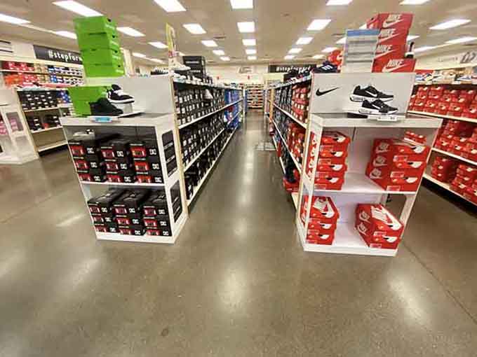Rows of Nike boxes stacked like sneaker treasure chests, each one holding potential savings and athletic dreams.