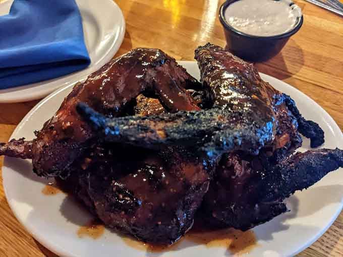 These wings wear their char marks like badges of honor, sticky with sauce and impossible to resist.