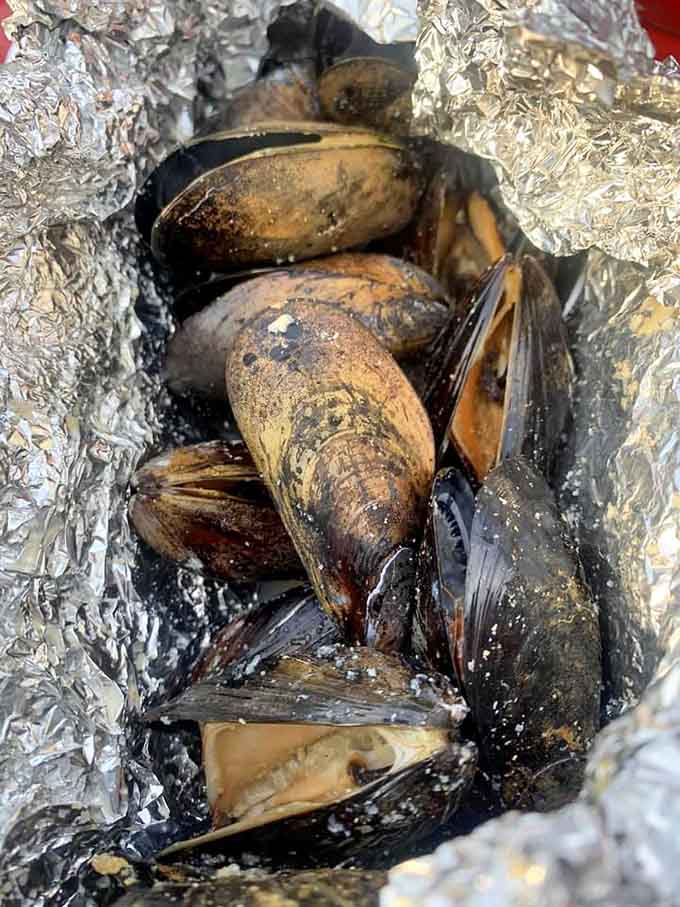These wine and garlic mussels arrive wrapped in foil like the world's most delicious present you get to open yourself.