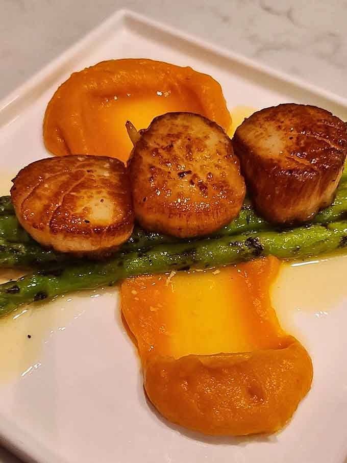 Golden scallops so beautifully caramelized, they could make a vegetarian reconsider their life choices for a moment.