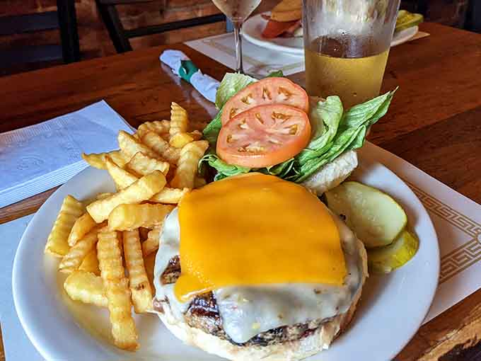 A burger topped with melted cheese and crispy fries, because sometimes simple perfection is all you need.