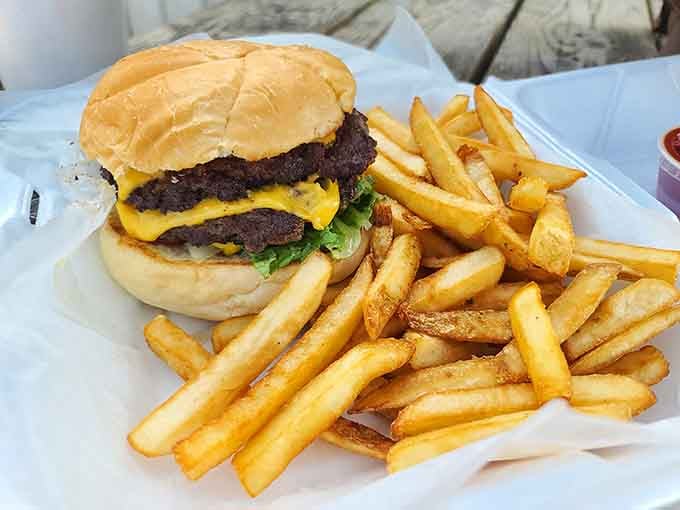 Two patties of pure joy stacked high enough to require strategic planning before your first bite.
