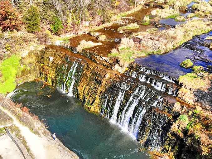 An aerial perspective reveals the falls' tiered beauty, like geological layer cake served up over millions of years.