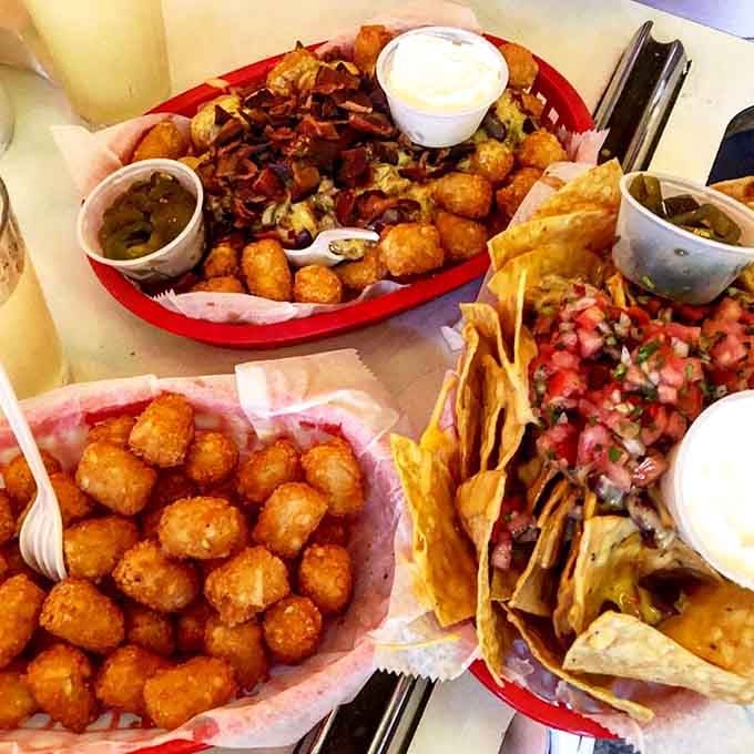 Tater tots and nachos sharing a plate like old friends who finally got their act together.