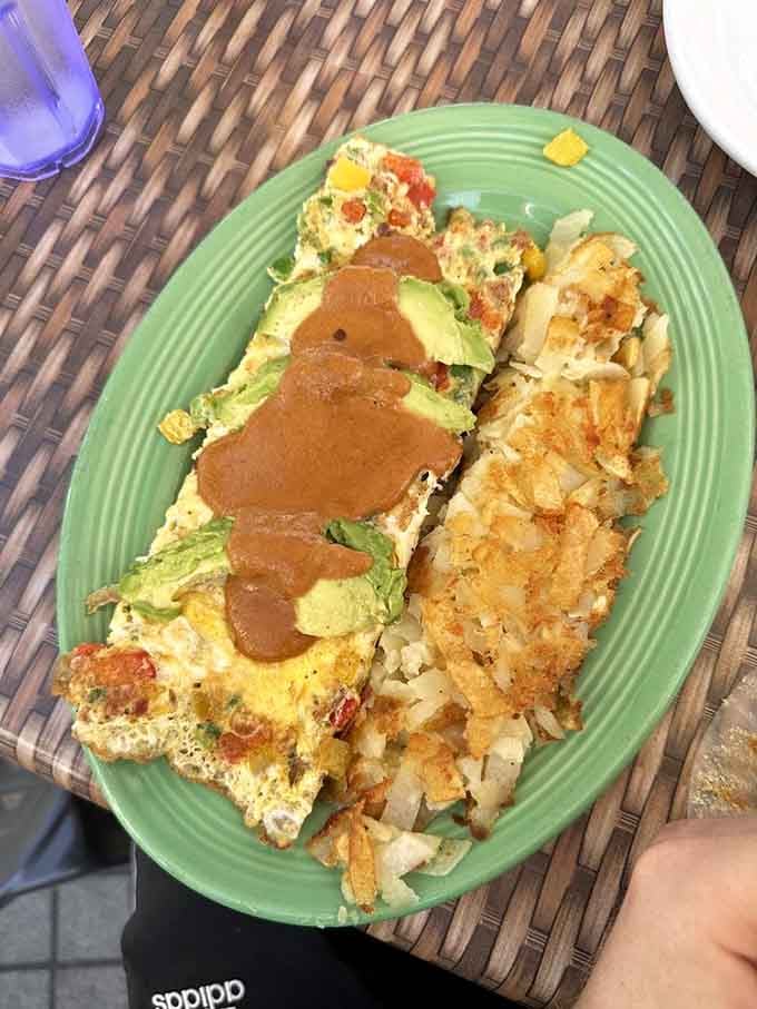 That omelet is stuffed so generously, it's practically bursting with pride, and those crispy hash browns deserve their own fan club.