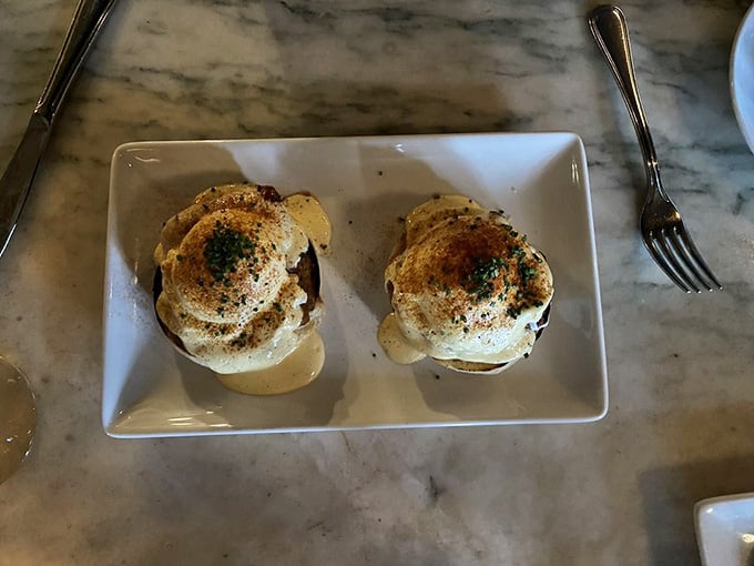 Those golden-topped benedicts sitting pretty on their pedestals are basically edible architecture, and I'm here for it.