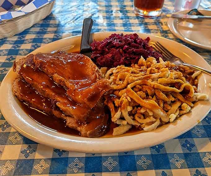 That roasted pork shank swimming in gravy with red cabbage and sp&auml;tzle is basically a German hug on a plate.