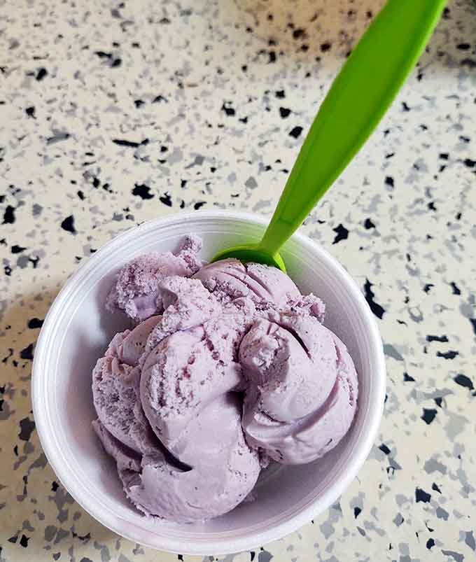 Purple ice cream in a simple cup reminds us that sometimes the best pleasures are the uncomplicated ones.