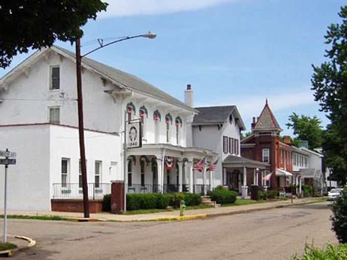 Victorian-era buildings house real businesses, not overpriced boutiques selling candles that cost more than groceries.