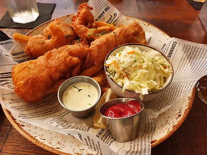 Golden, crispy fish and chips arrive with coleslaw, reminding us why classic pub fare never goes out of style.