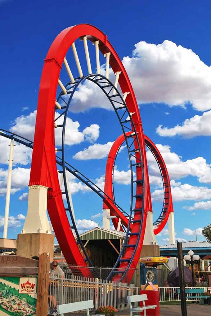 The Texas Tornado's red loops slice through blue sky like a rollercoaster designer's fever dream.