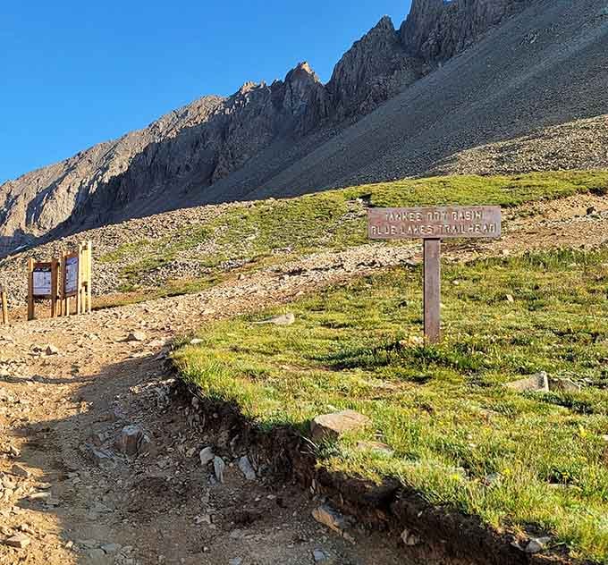 Trail markers guide adventurers toward Blue Lakes, where turquoise waters reward those who climb higher.