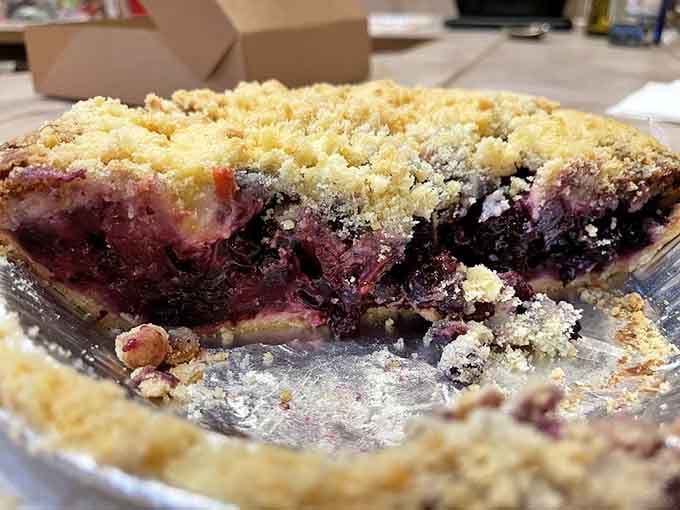 That deep purple filling isn't just blueberries; it's summer vacation captured in a pie tin forever.