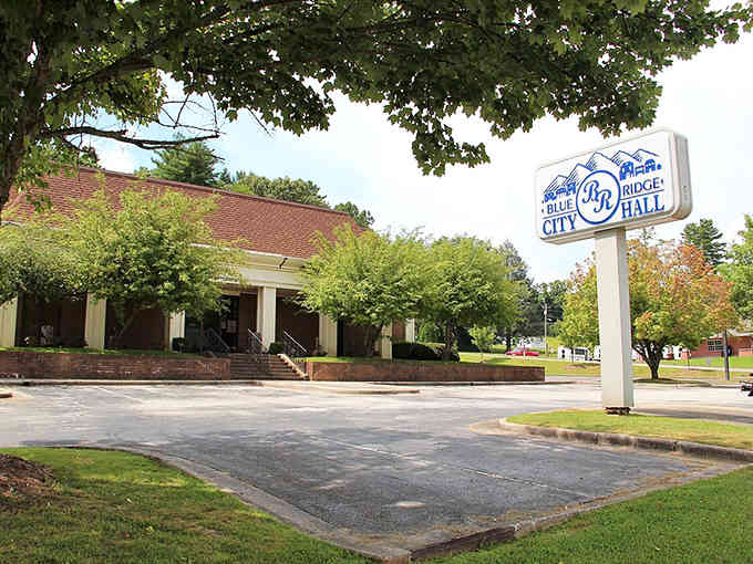 This city hall is shaded and serene, standing with the quiet confidence of a well-aged cheddar and white columns.