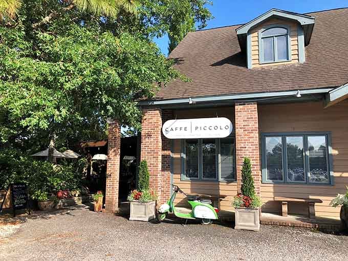 A bright green Vespa parked outside this brick building hints at the Italian adventure waiting inside and on the patio.