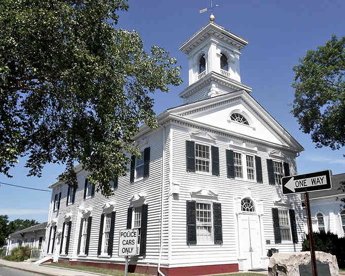 Classic white clapboard architecture stands proud, reminding us that some traditions never go out of style beautifully.