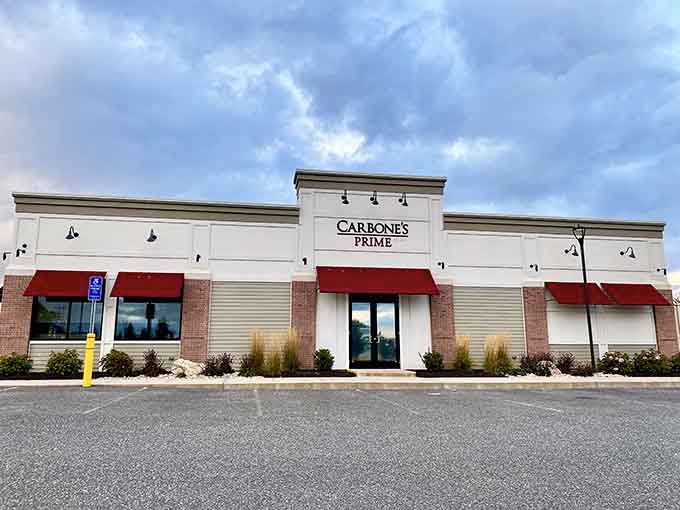Those bold red awnings against clean white siding signal classic Italian-American steakhouse excellence done right with style.